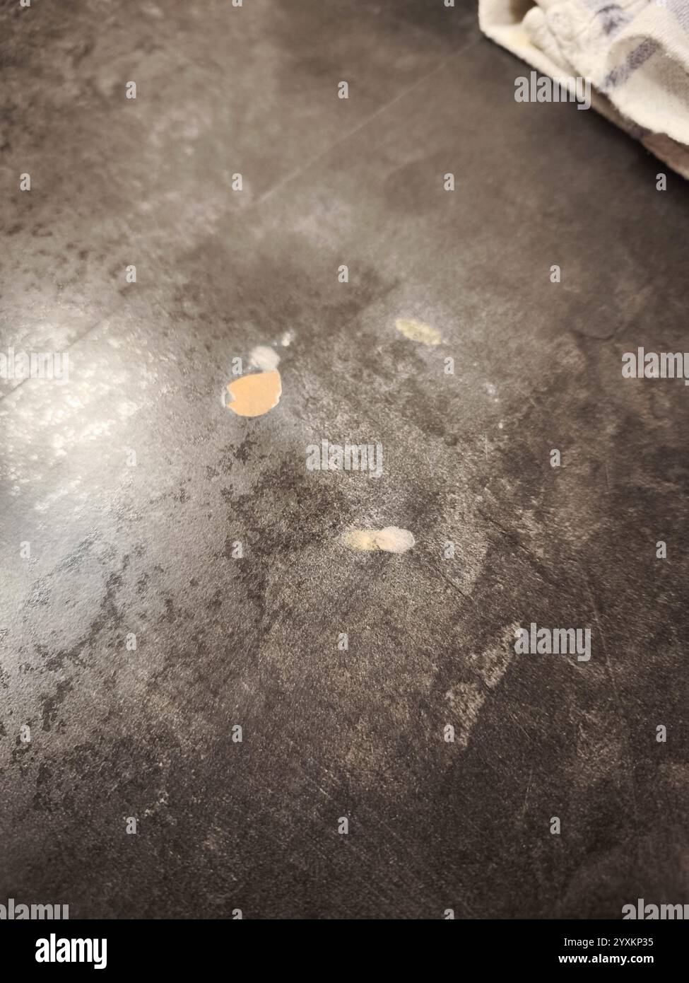 Damaged countertop showing peeling laminate and particleboard ...