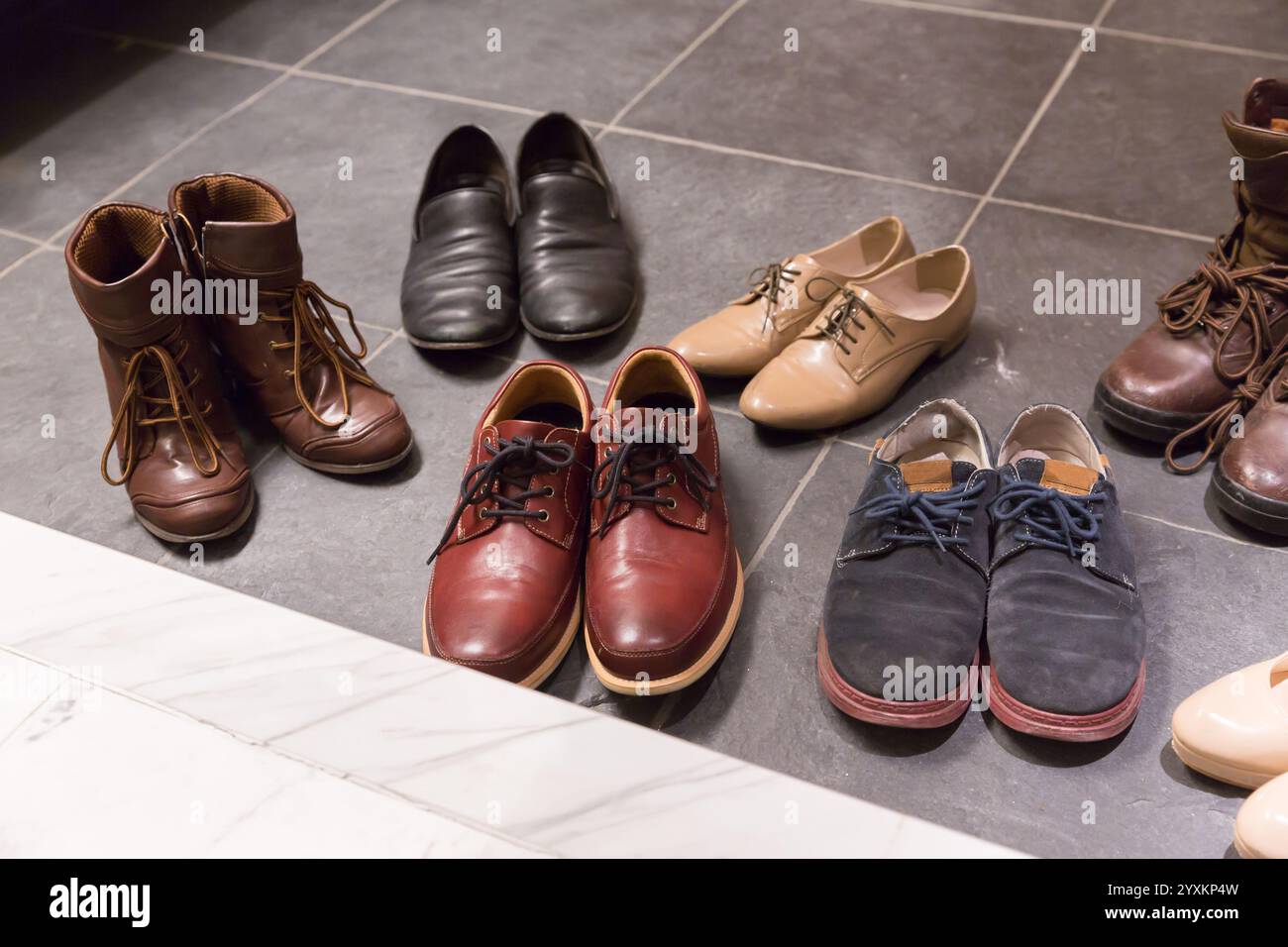 Entrance hallway lined with shoes Stock Photo - Alamy