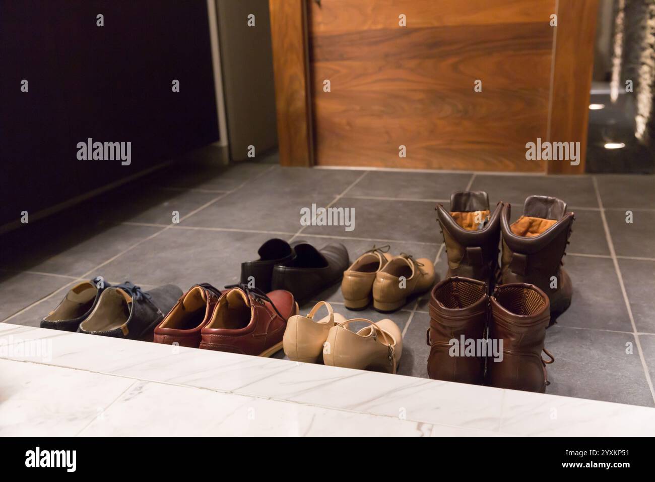 Entrance hallway lined with shoes Stock Photo - Alamy