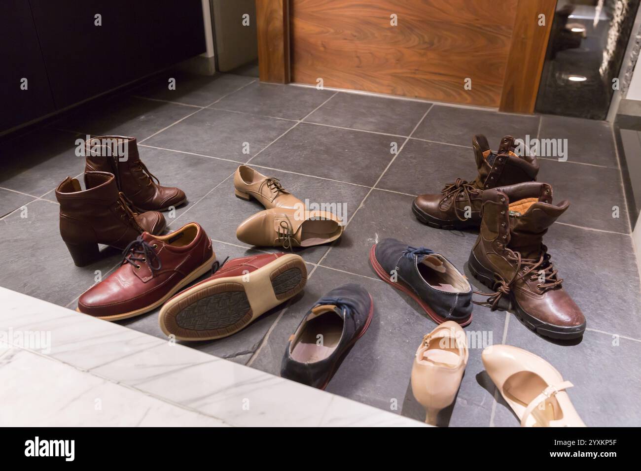 Entrance hallway lined with shoes Stock Photo - Alamy
