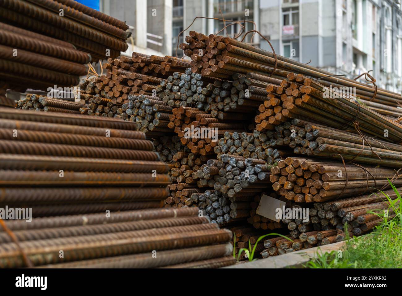 Stack of rusty metal reinforcement bars lying outdoors waiting for ...