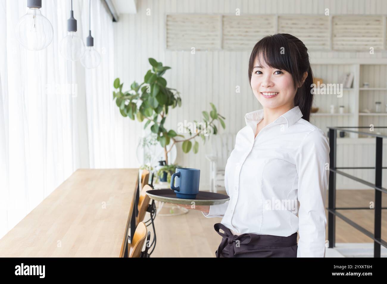 Female staff at the café Stock Photo - Alamy