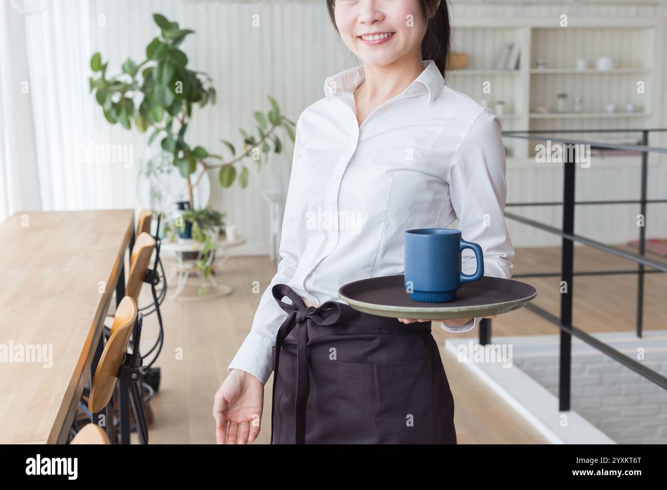 Female staff at the café Stock Photo - Alamy