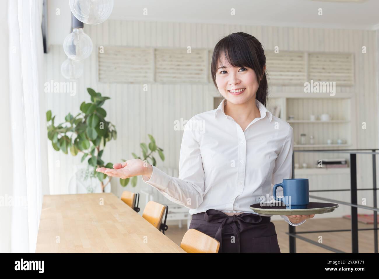 Female staff at the café Stock Photo - Alamy