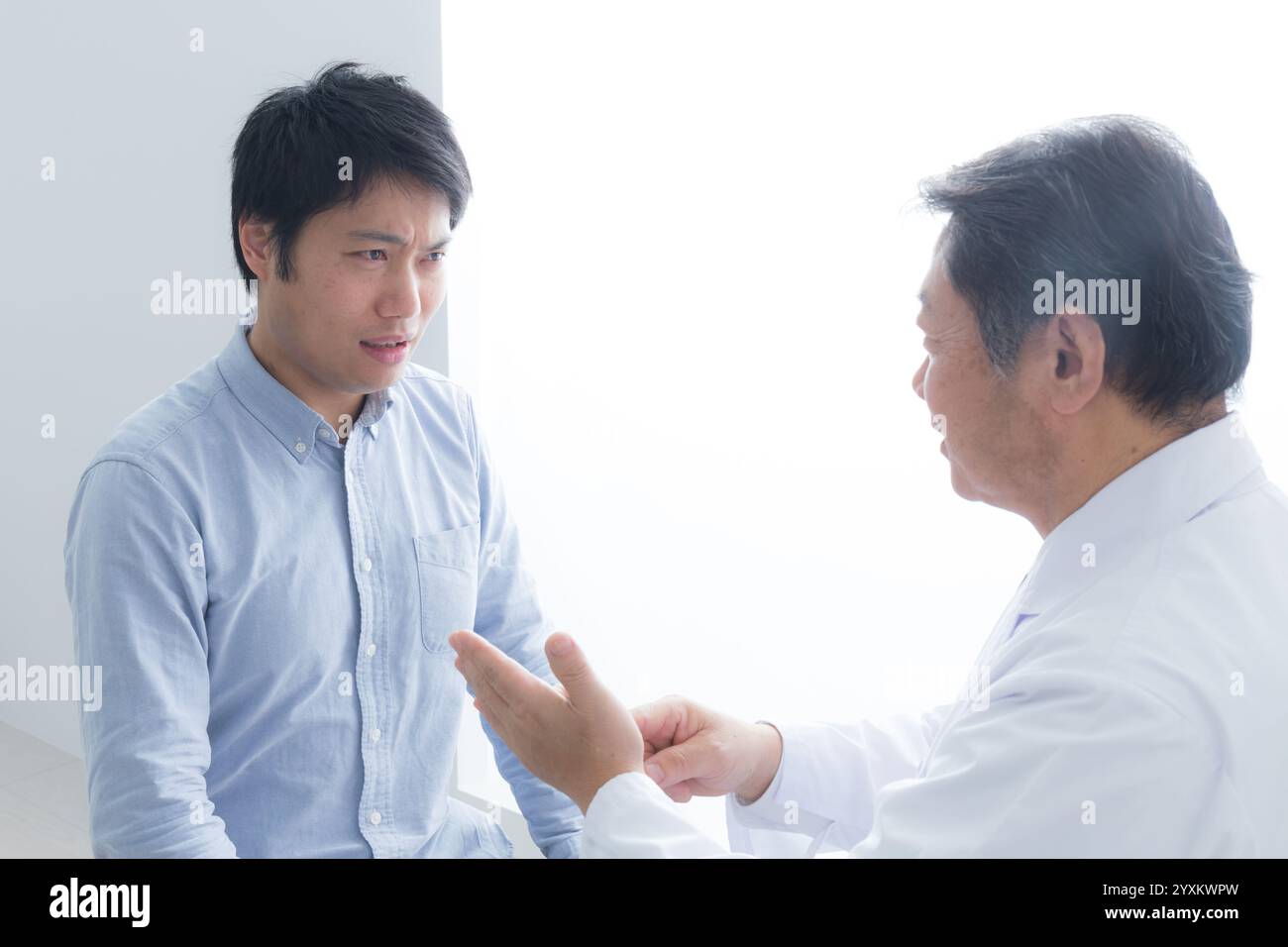 Male doctor and patient Stock Photo - Alamy