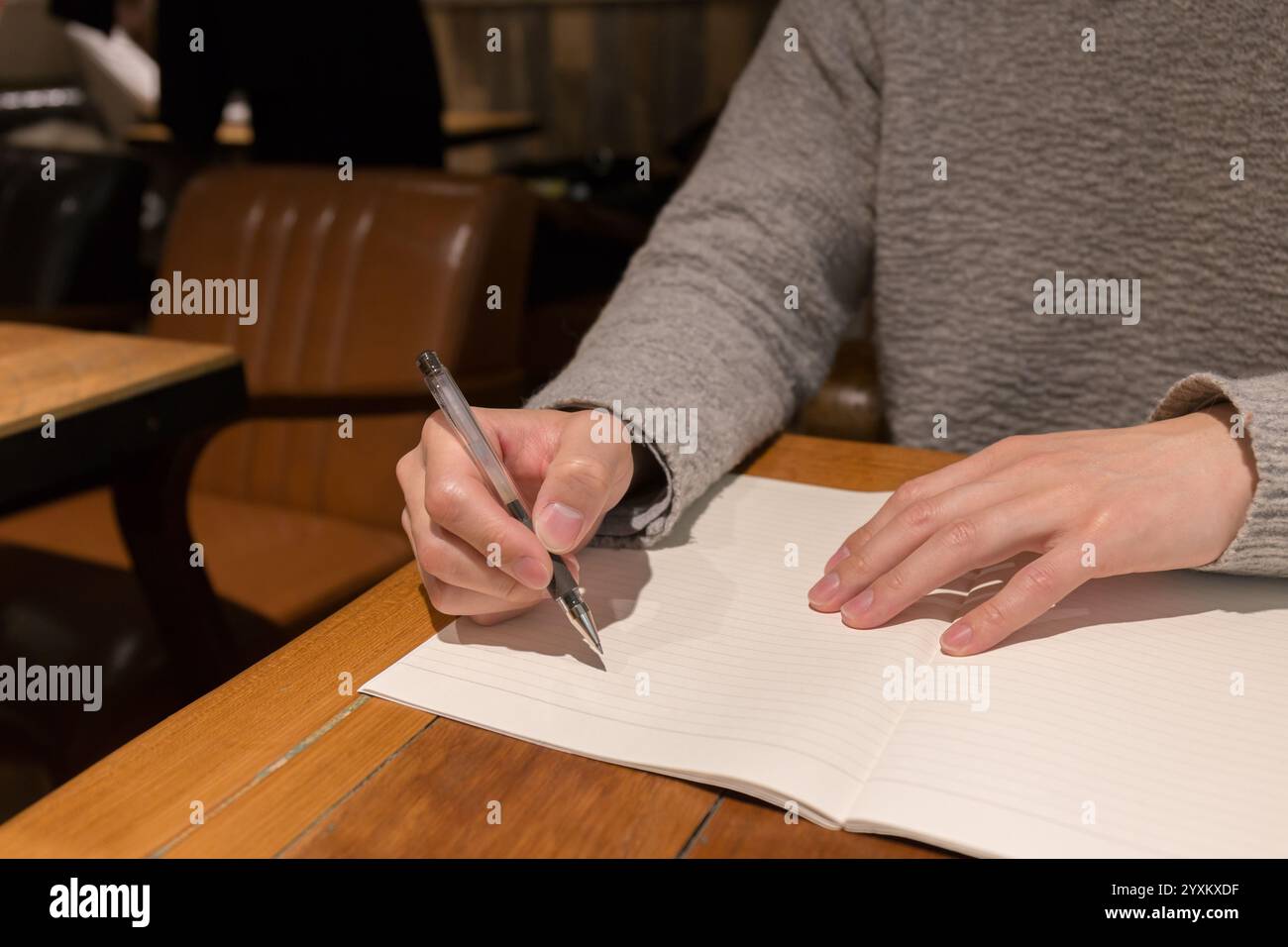 People writing notes in a café Stock Photo - Alamy