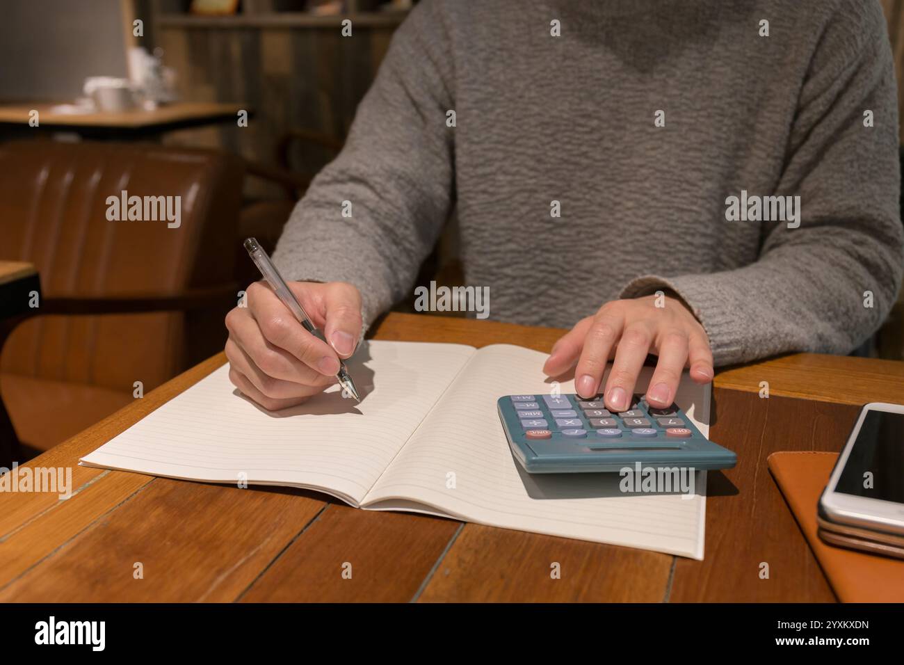 People doing calculations in café Stock Photo - Alamy