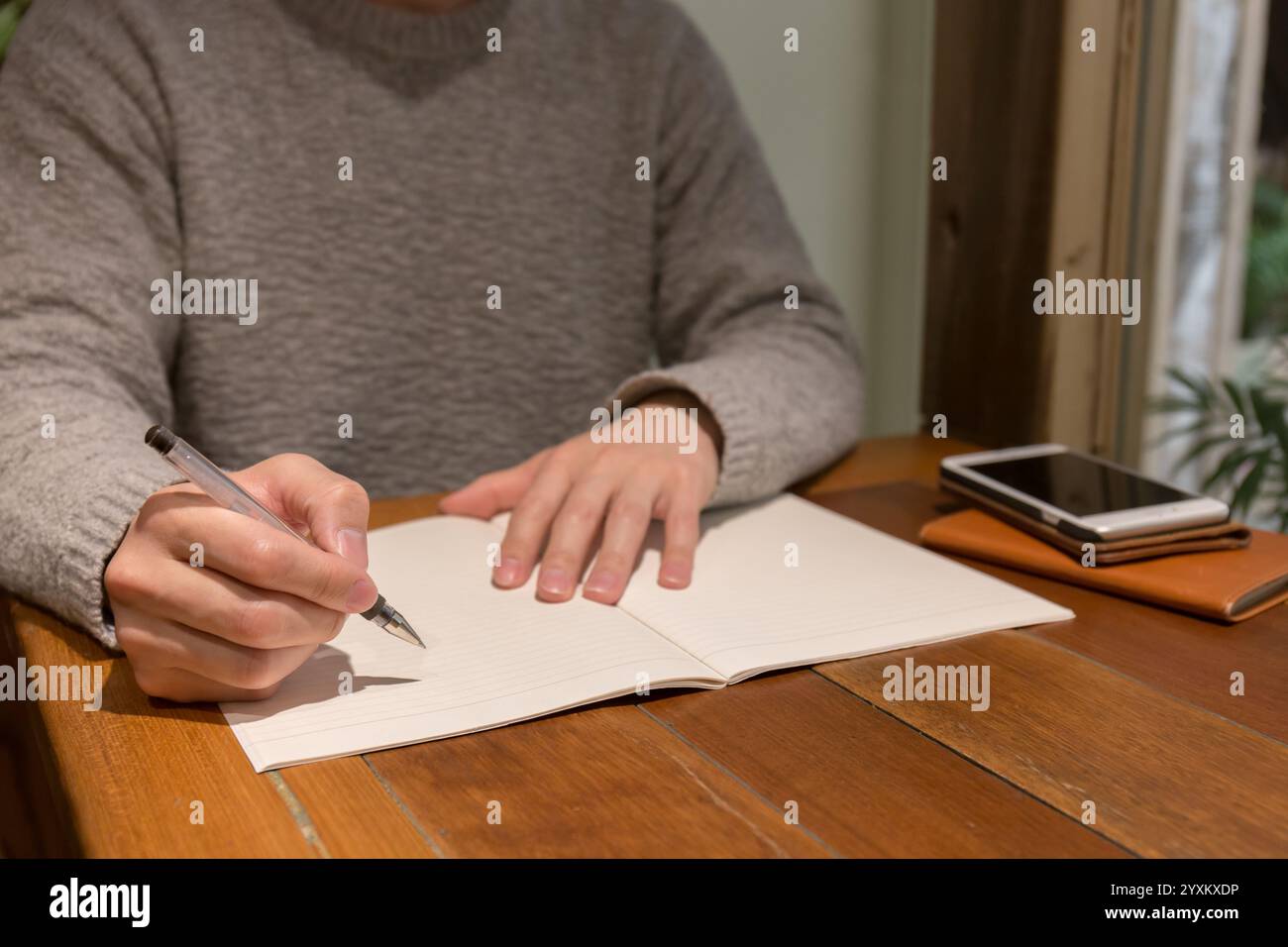People writing notes in a café Stock Photo - Alamy