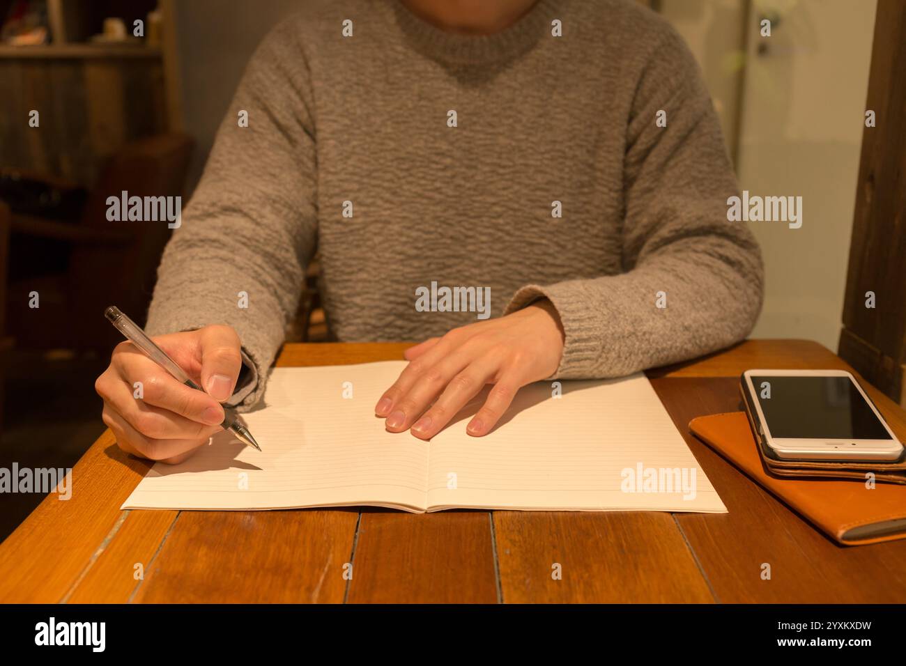 People writing notes in a café Stock Photo - Alamy