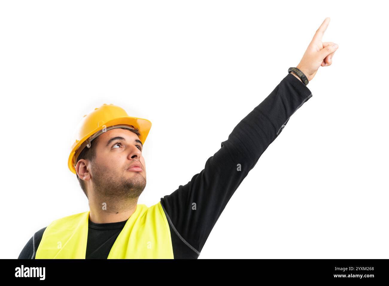 Adult male construction worker pointing index finger at blank copyspace ...