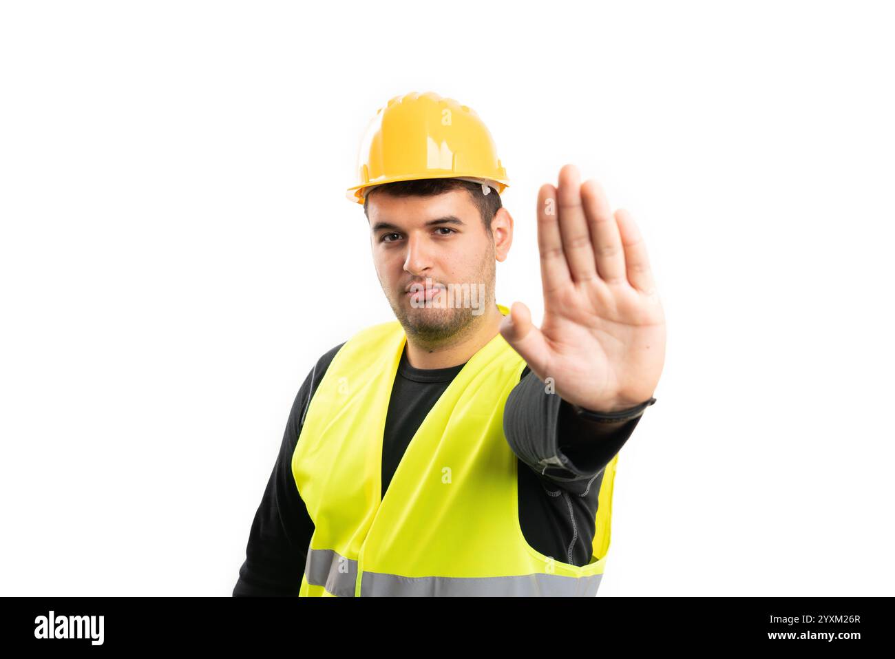 Serious male construction worker wearing yellow safety helmet and vest ...