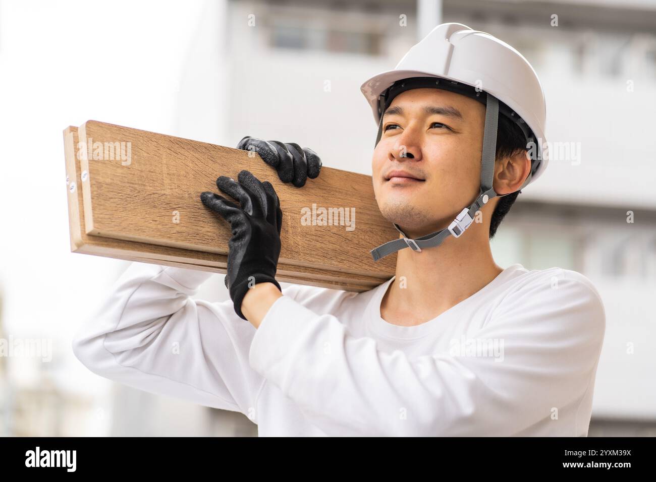 Male worker with building materials Stock Photo - Alamy
