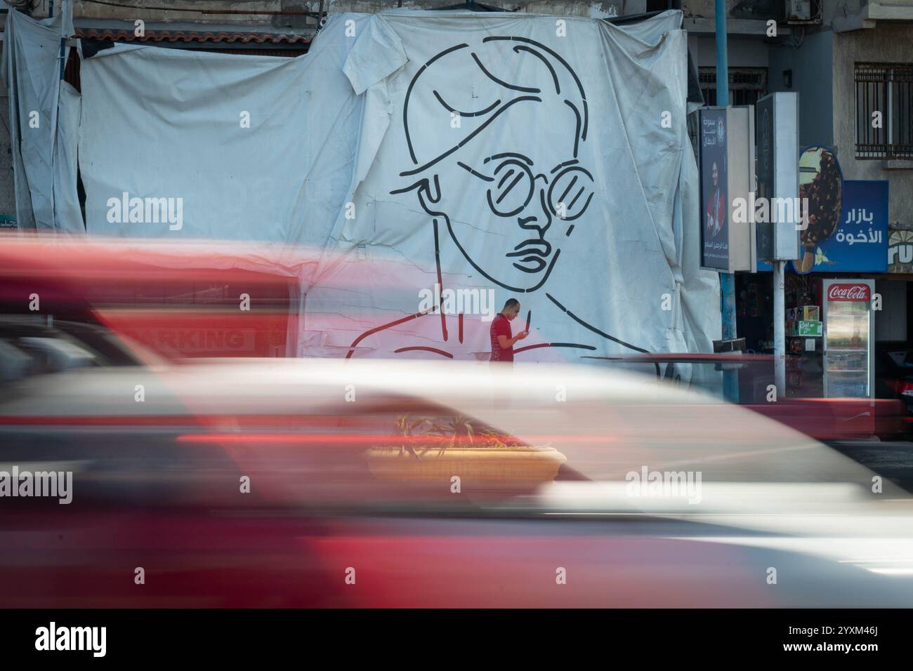 A dynamic street scene in Alexandria, Egypt, featuring a mural of a ...