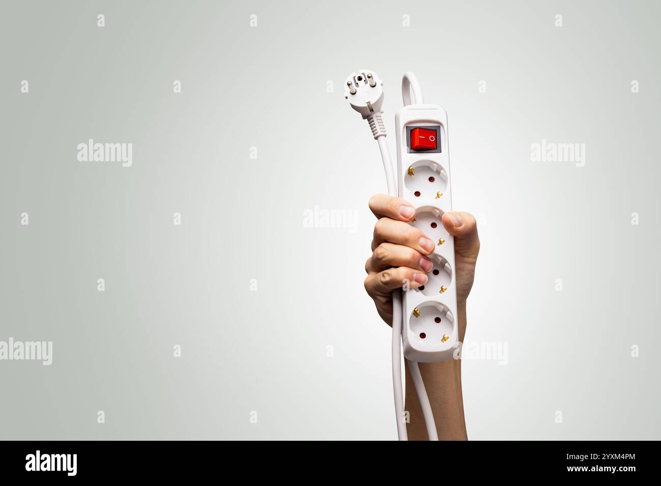 Hand holding a European power strip with extension cord Stock Photo - Alamy
