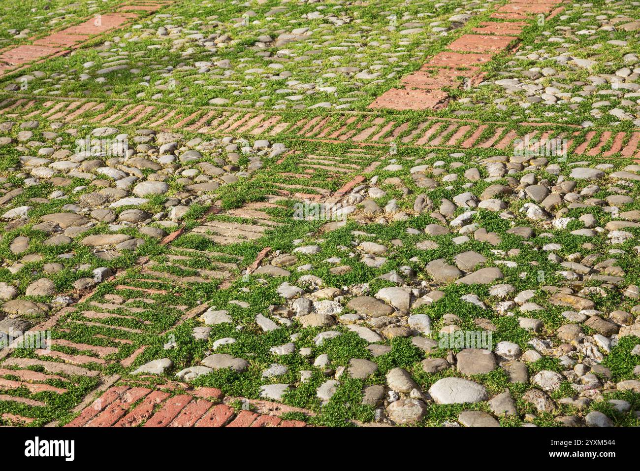 Stone old road with grass background Stock Photo - Alamy
