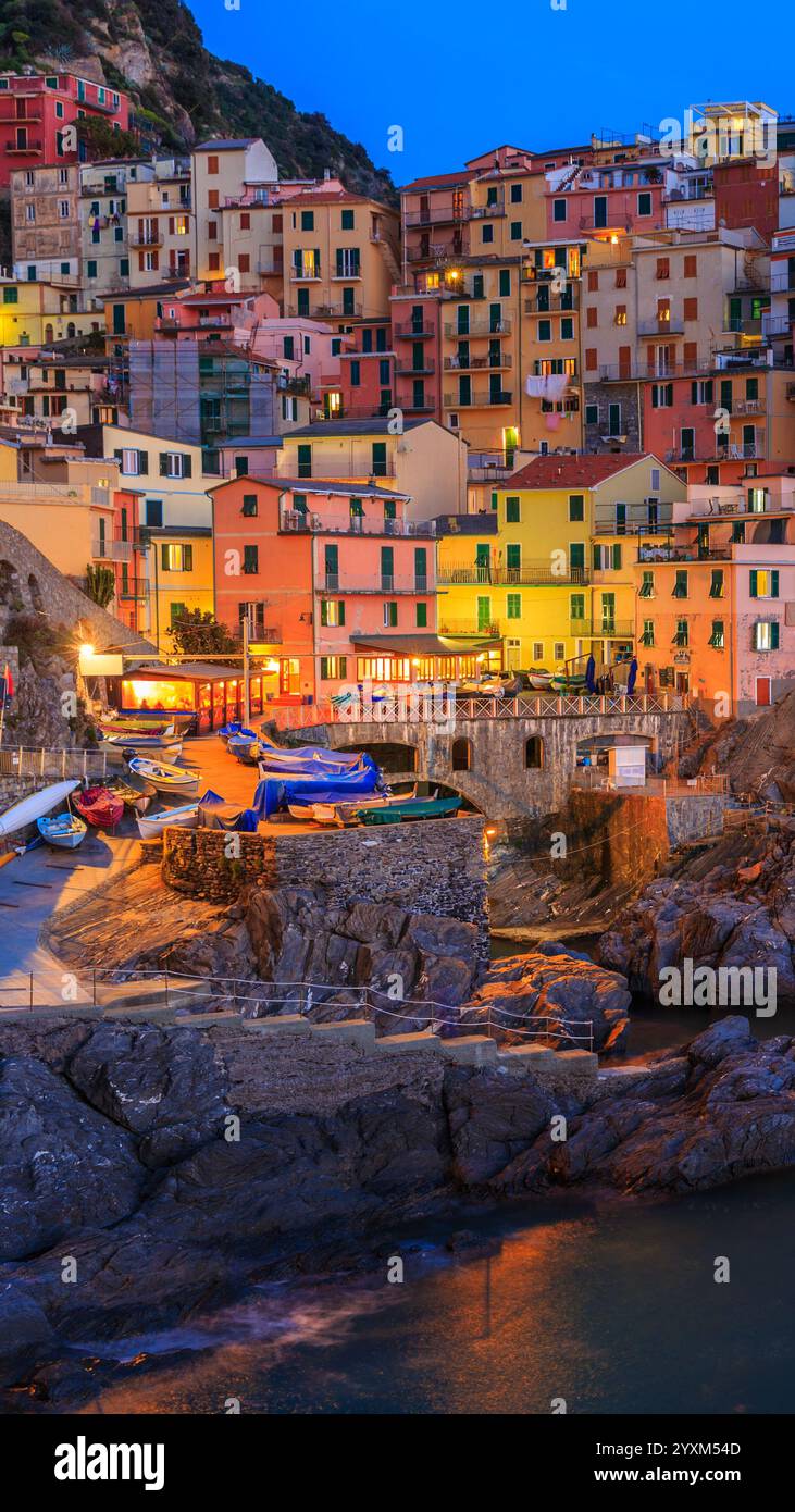 Manarola village at night with colorful houses perched on cliffs ...