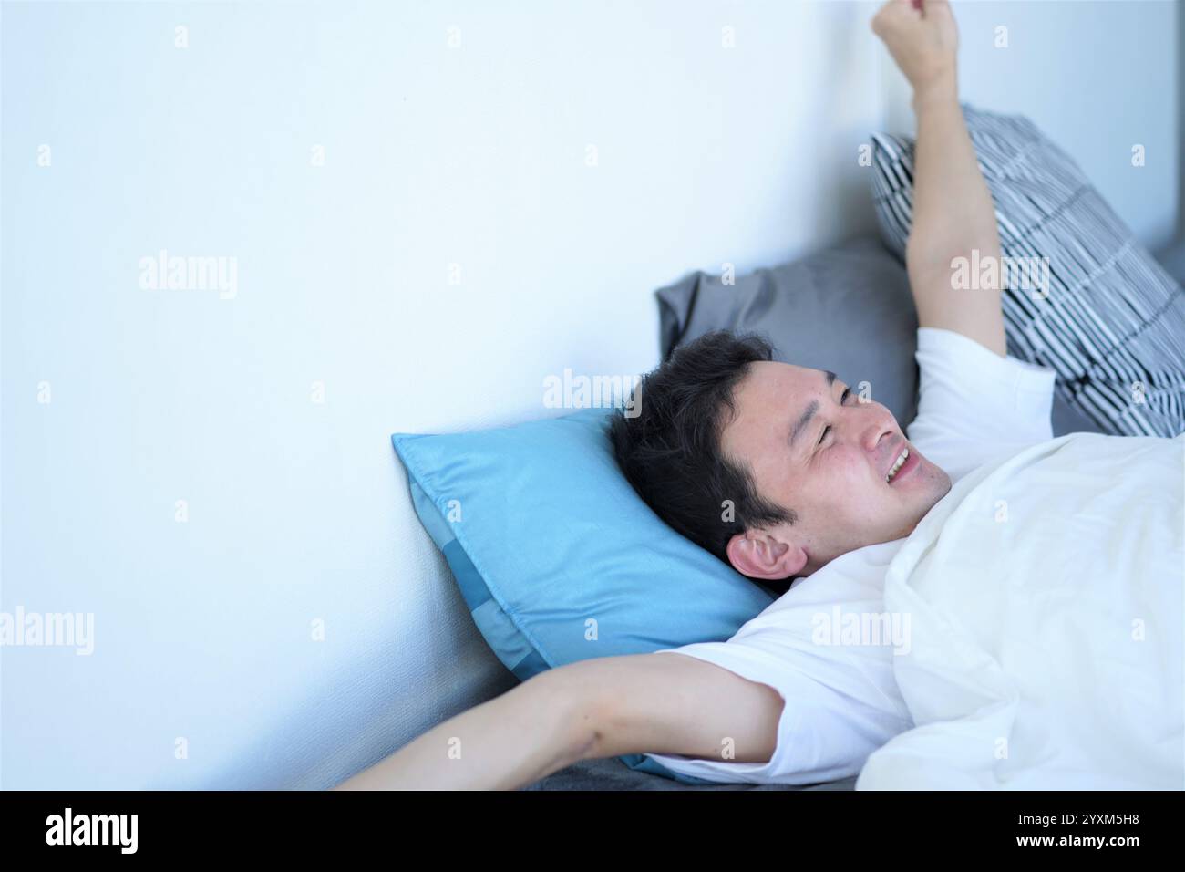 Man on bed Stock Photo - Alamy