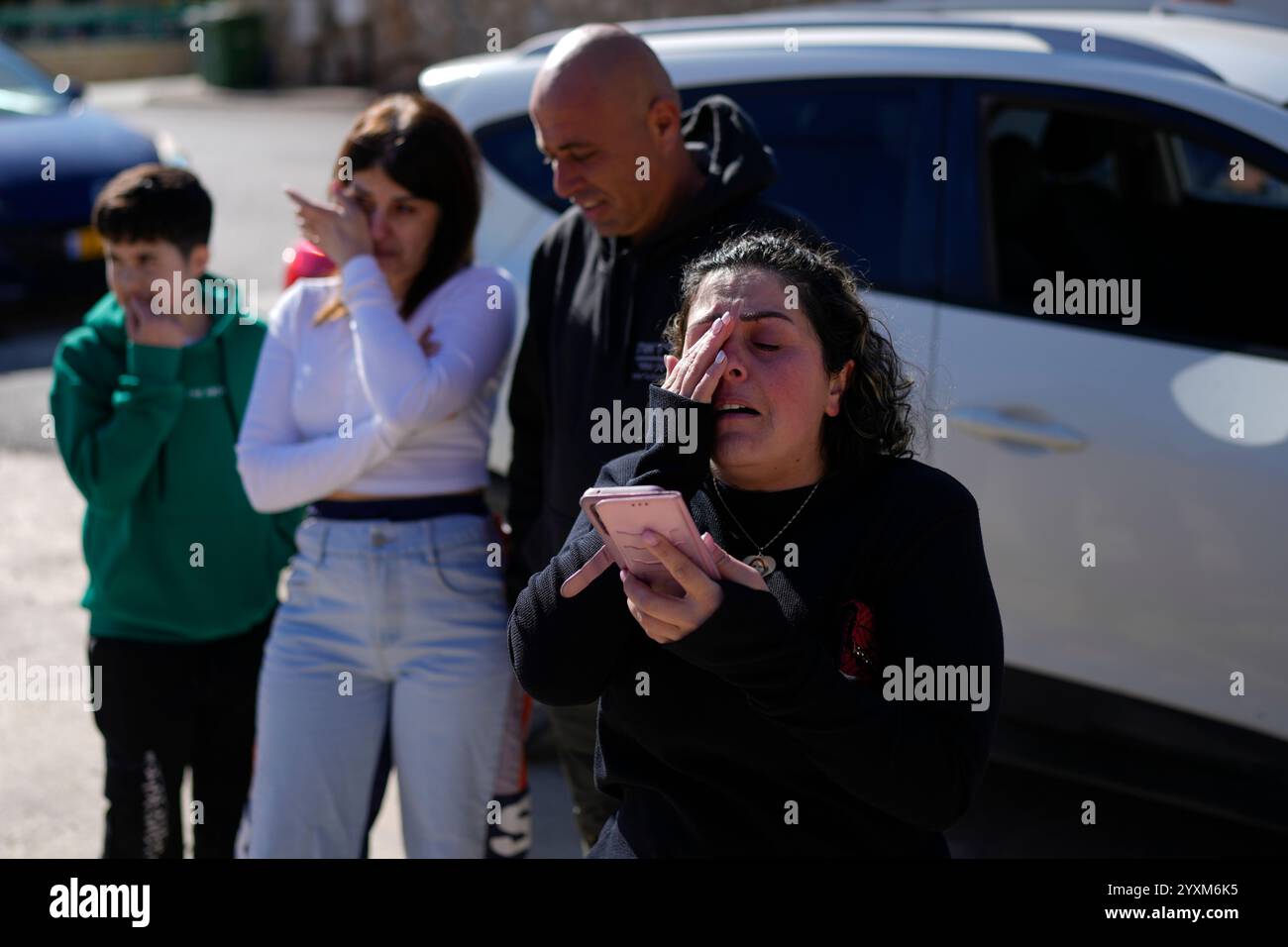 Salma Safadi cries as she speaks with her sister Sawsan Safadi, who is ...