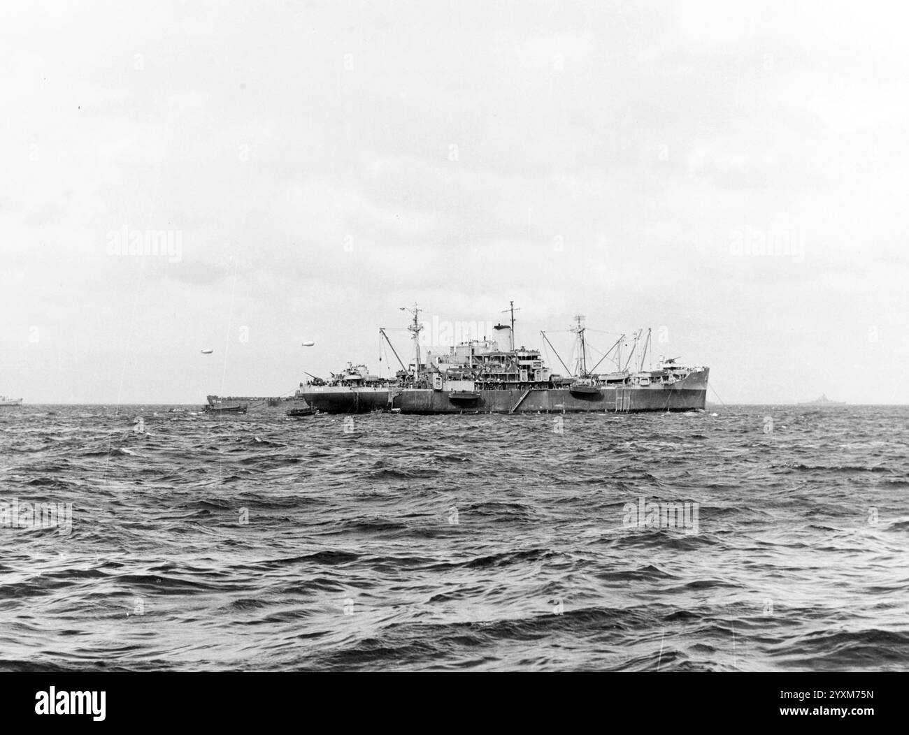 USS Bayfield (APA-33) lowering landing craft off Utah Beach on 6 June ...