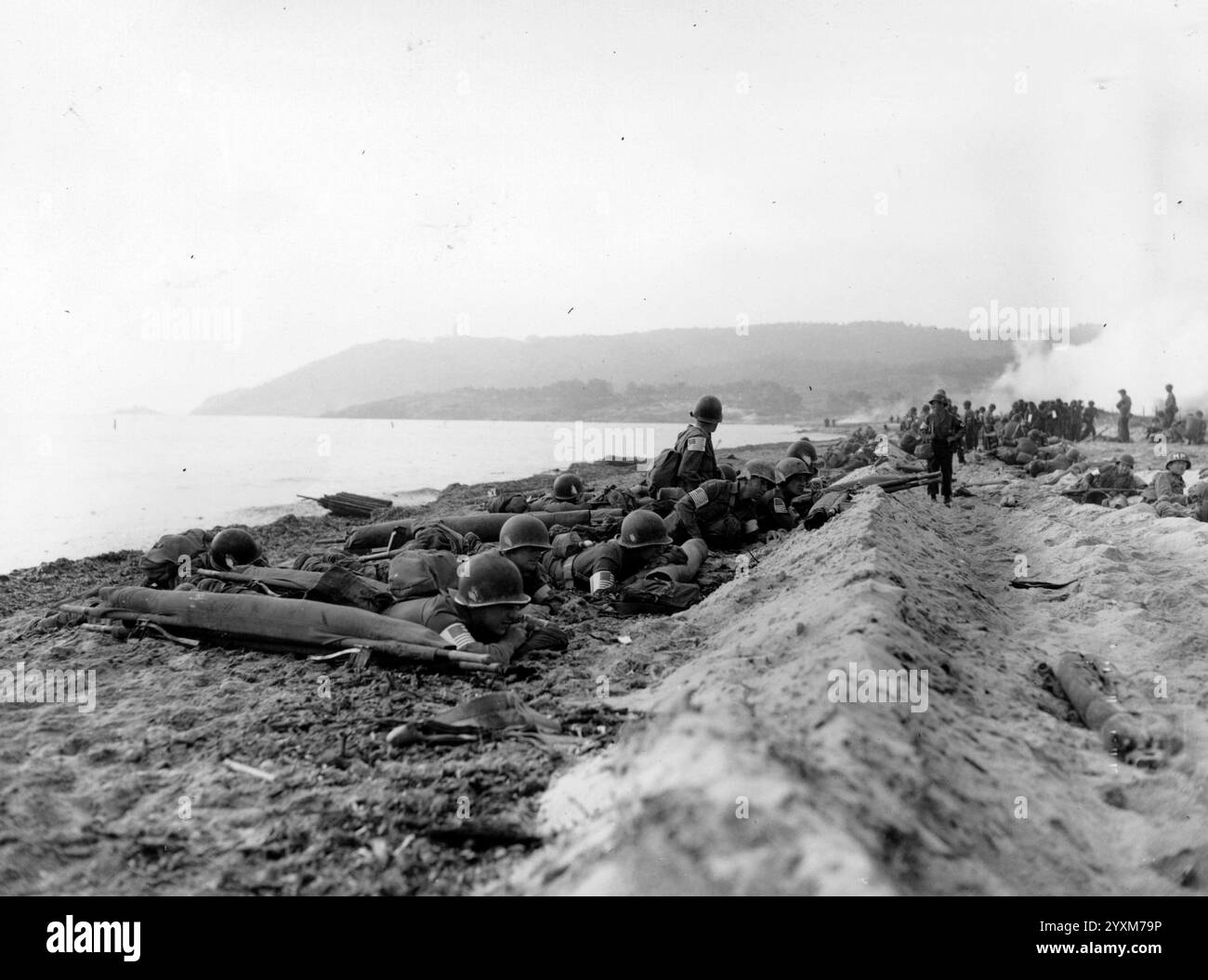 American medics and MPs of the 7th Army hugging the beach during German ...