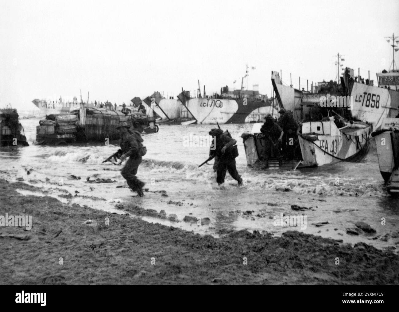 Commandos are seen here wading ashore from landing craft, onto the ...