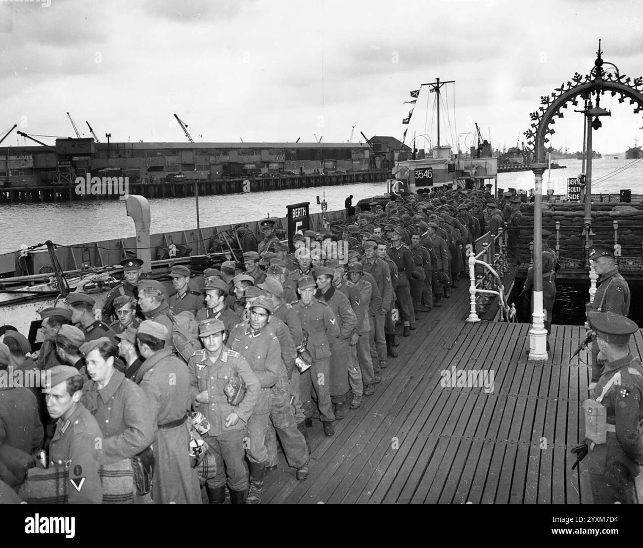 German prisoners of war debark from a British LCT (with number 3546) at ...