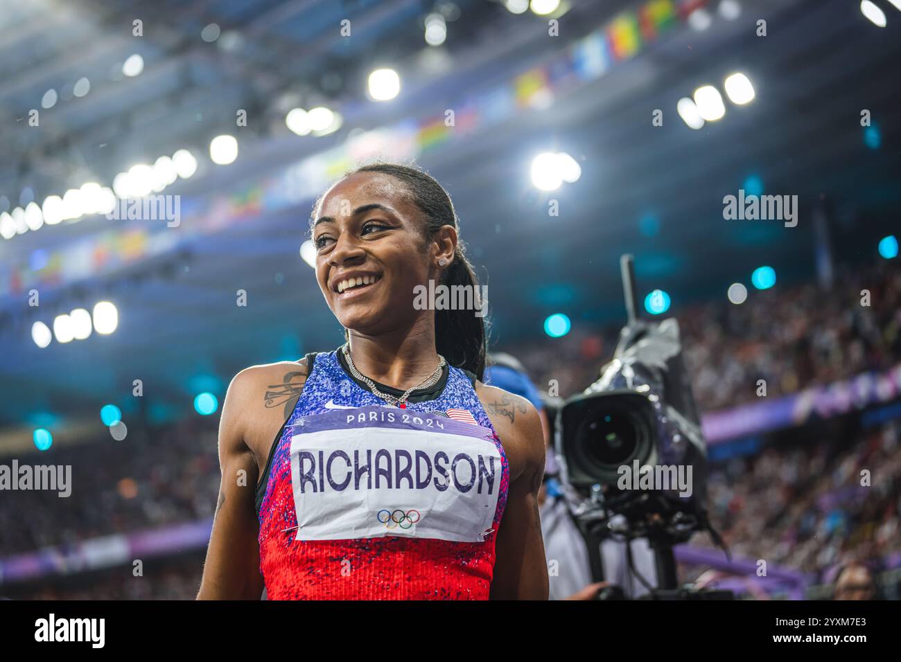 Sha'Carri Richardson celebrating her medal with her country's flag at ...