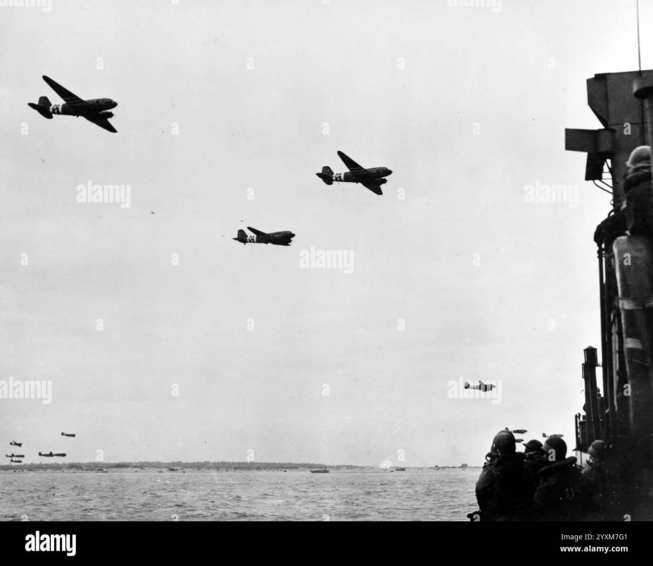 U.S. Army Air Forces C-47 transport planes fly low over a Coast Guard ...