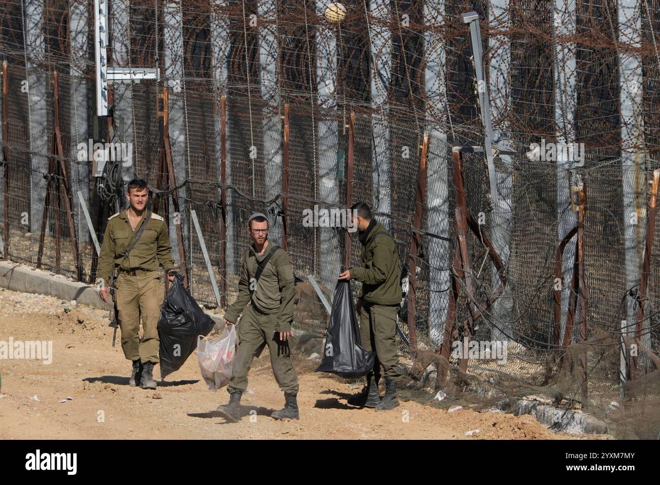 Israeli soldiers clean along the so-called Alpha Line that separates ...