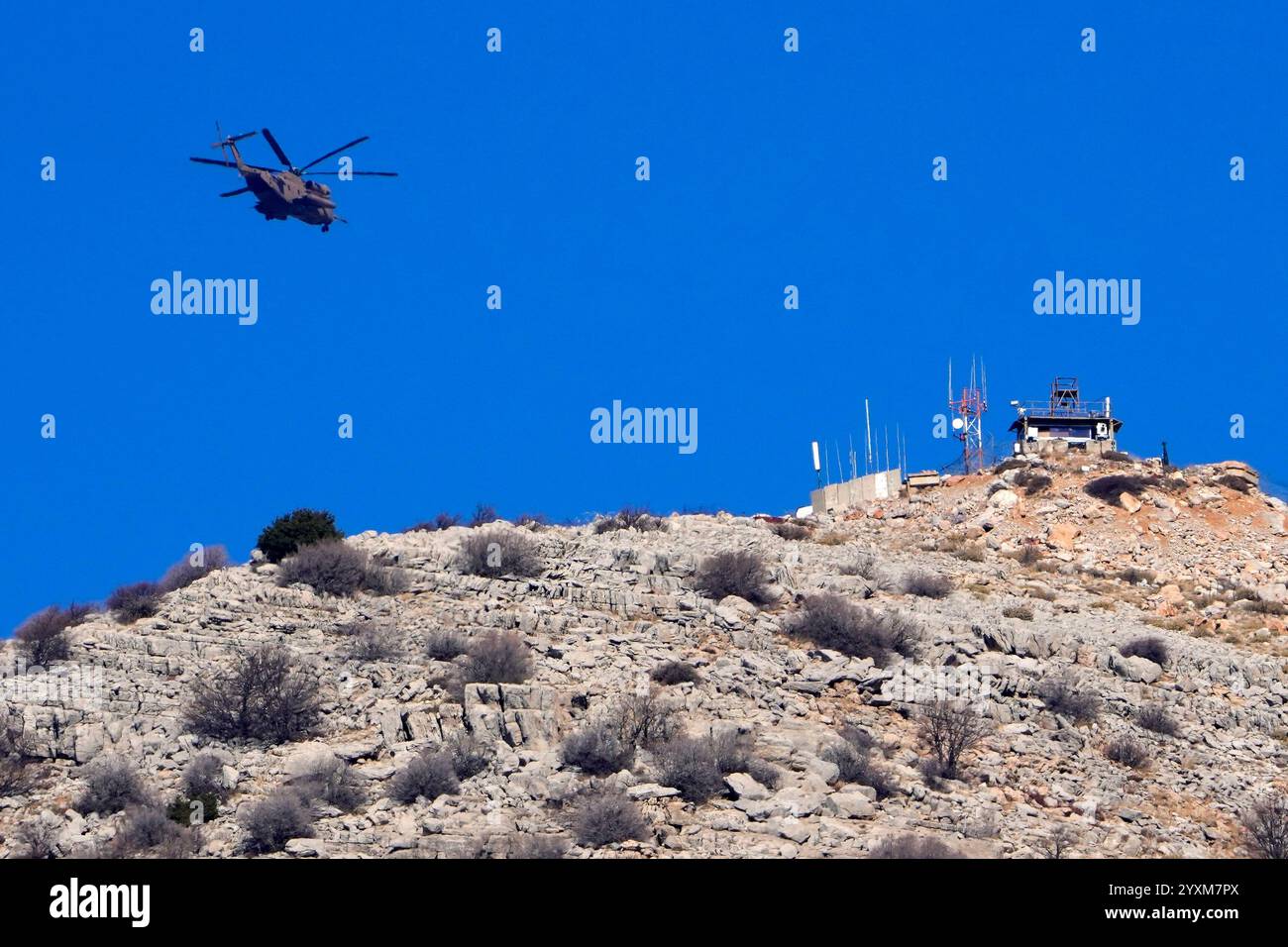 An Israeli Air Force Black Hawk helicopter flies over Mount Hermon ...