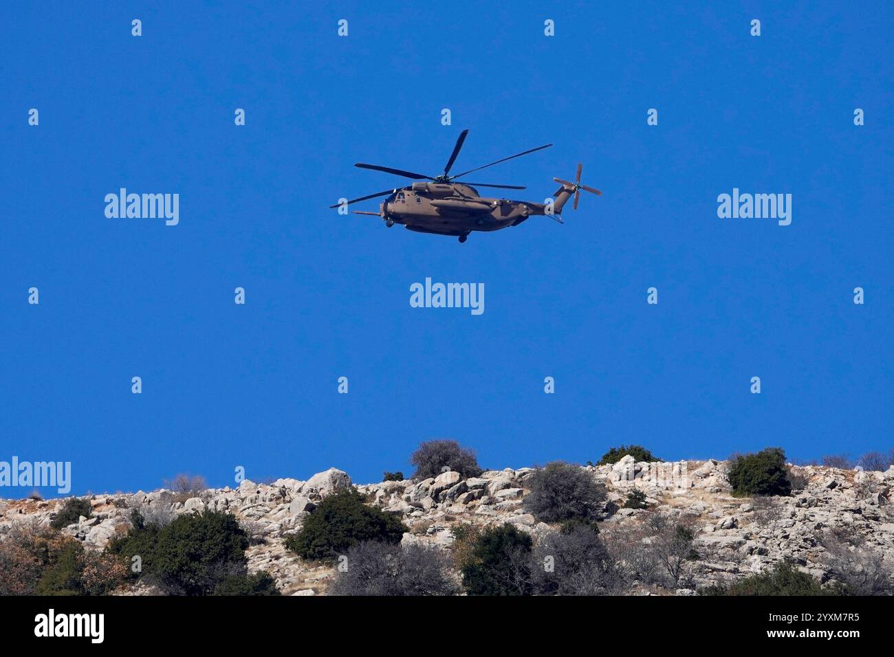 An Israeli Air Force Black Hawk helicopter flies over Mount Hermon near ...