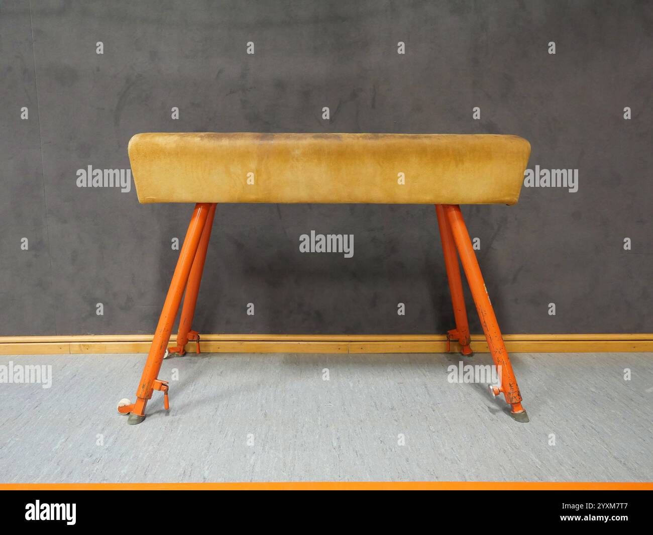 A gymnastics buck horse in an old sports hall from the 80s is well ...