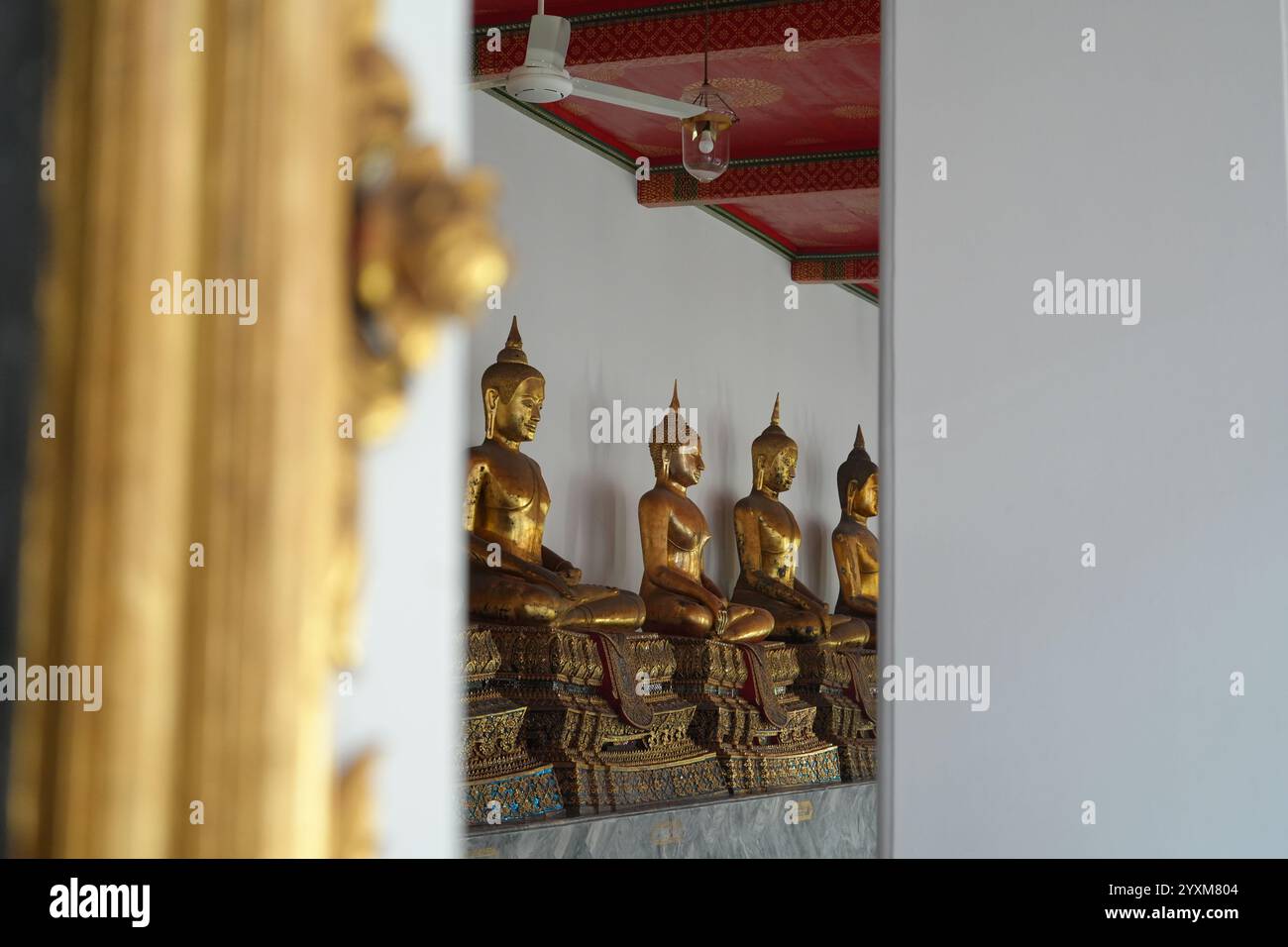 Bangkok, Thailand - November 29, 2024: A row of golden Buddha statues ...