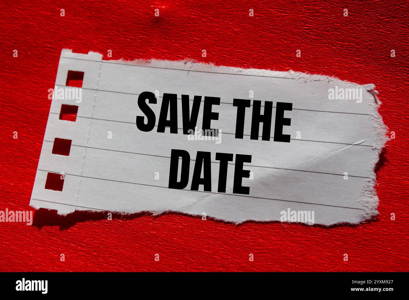 Save the date message written on ripped torn paper piece with red ...