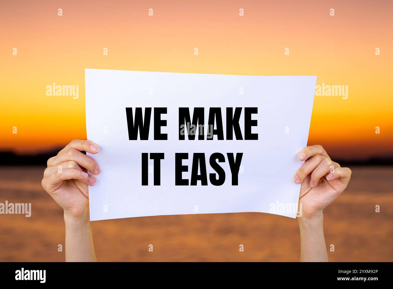 We make it easy message written on white paper with blurry lake ...