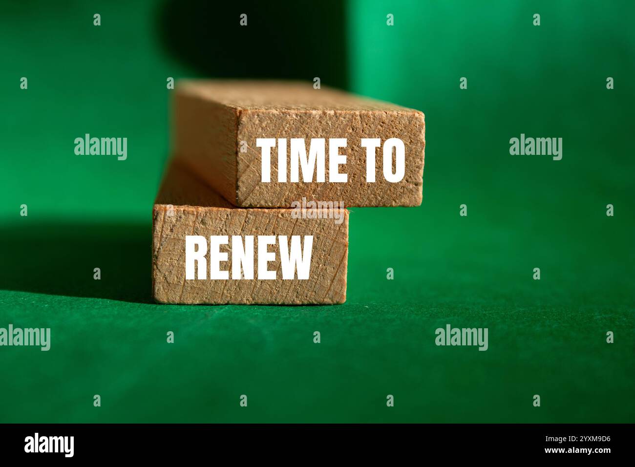 Time to renew message written on wooden blocks with green background ...