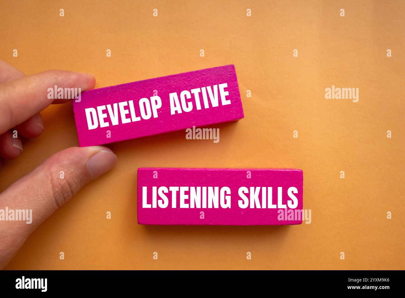 Develop active listening skills message written on pink wooden blocks ...