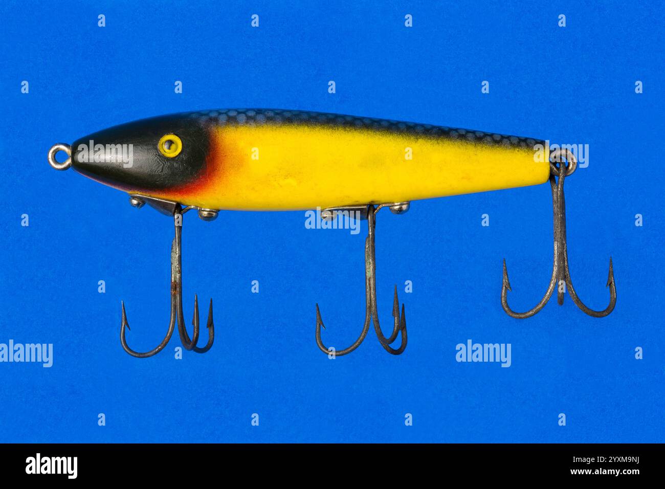 A vintage fishing lure with blue background Stock Photo - Alamy