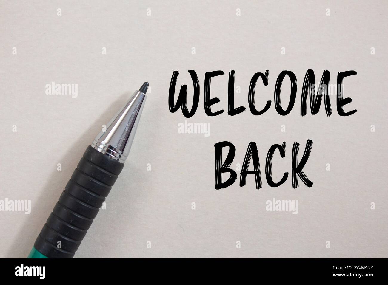 Welcome back message written on white paper with a pen. Conceptual ...