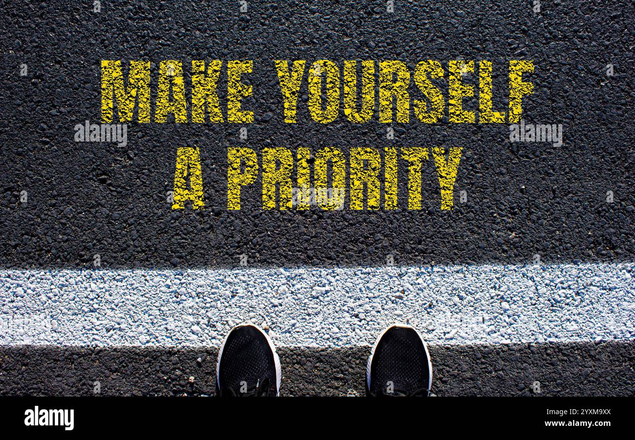 Make yourself a priority message written on asphalt road. Conceptual ...