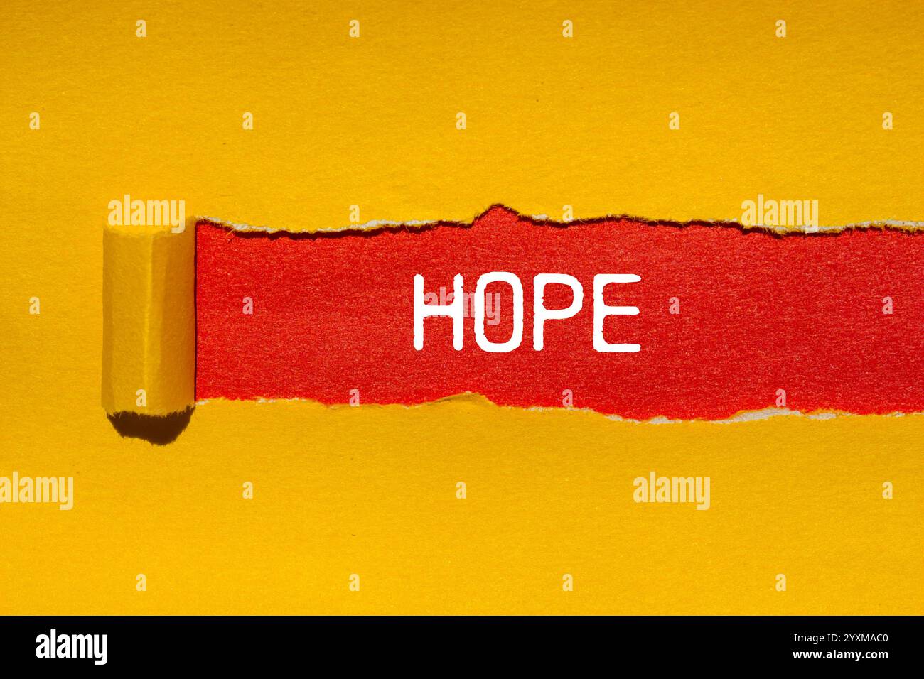 Hope message written on ripped torn yellow paper with red background. Conceptual hope symbol ...