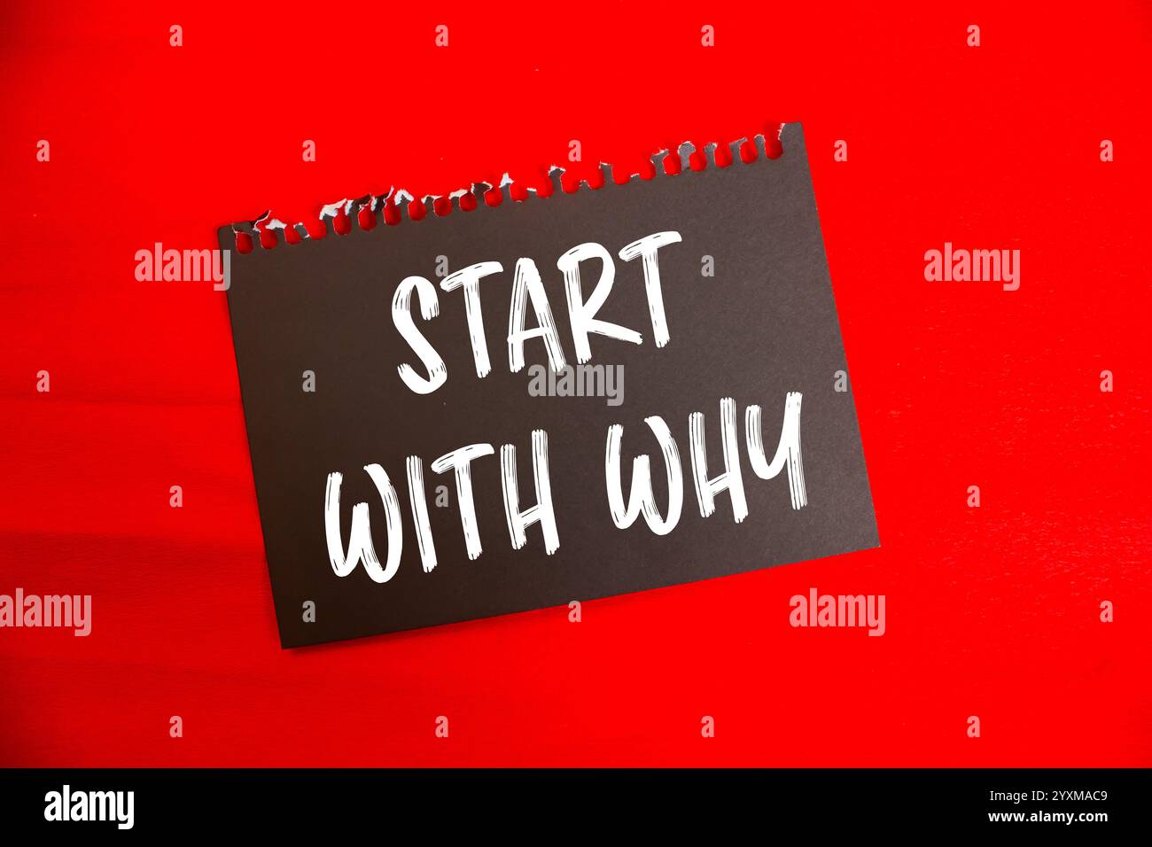 Start with why message written on black paper with red background ...
