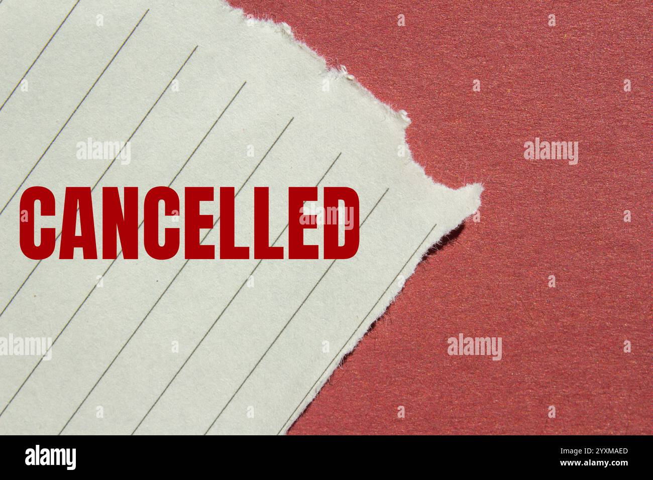 Cancelled message written on ripped torn lined paper with red background. Conceptual cancelled ...