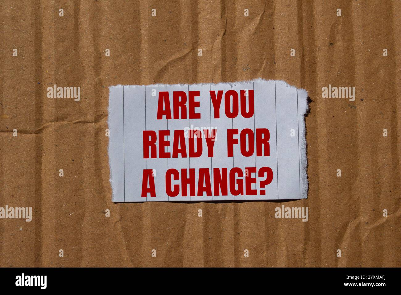 Are you ready for a change message written on ripped torn paper piece with cardboard paper ...