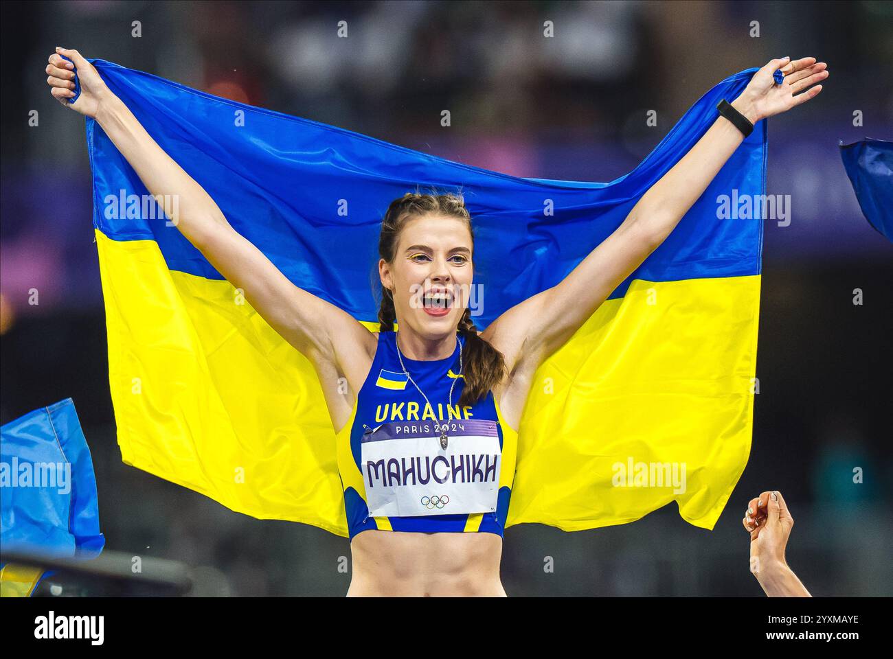 Yaroslava Mahuchikh celebrating her medal with her country's flag at ...