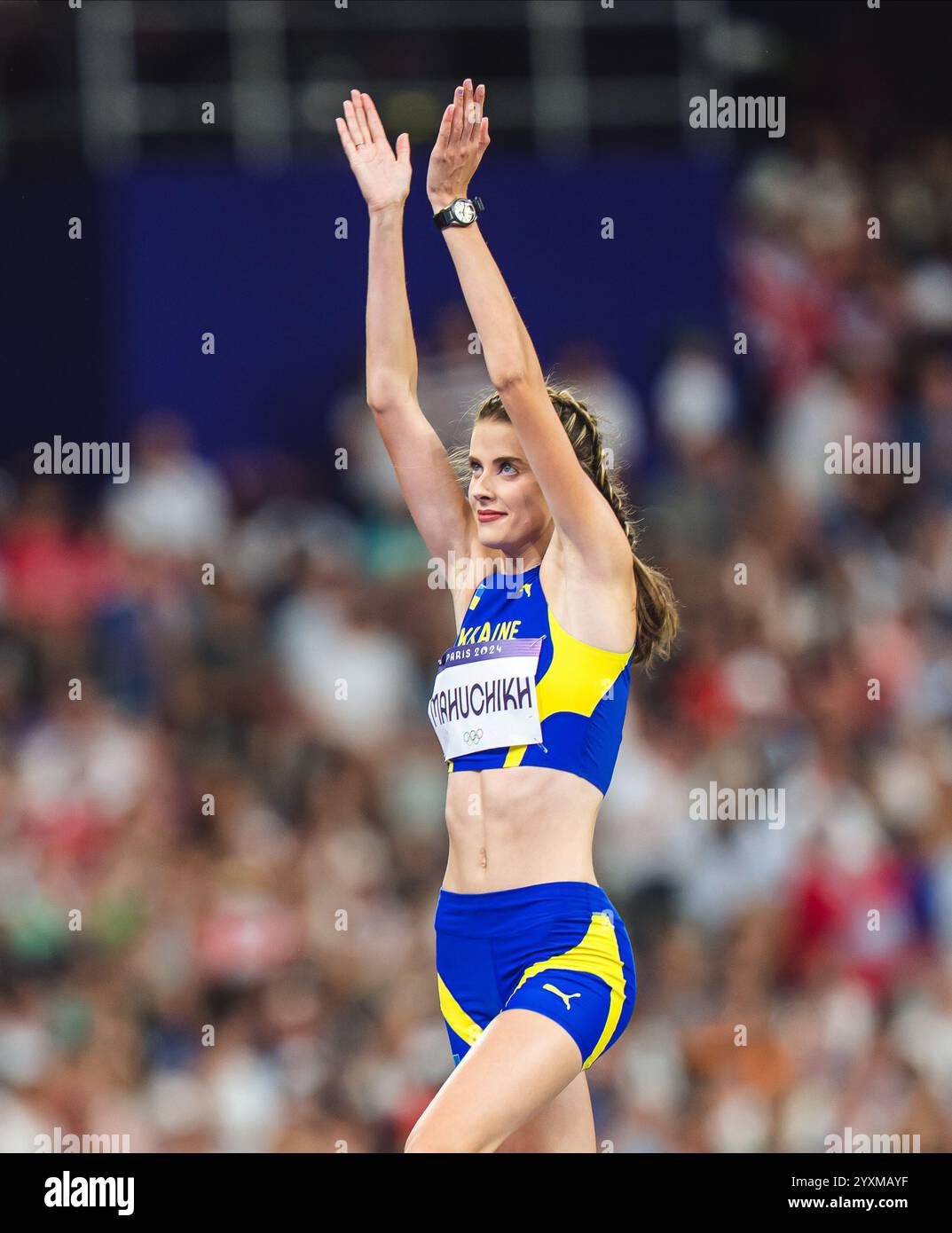 Yaroslava Mahuchikh celebrating her medal with her country's flag at ...