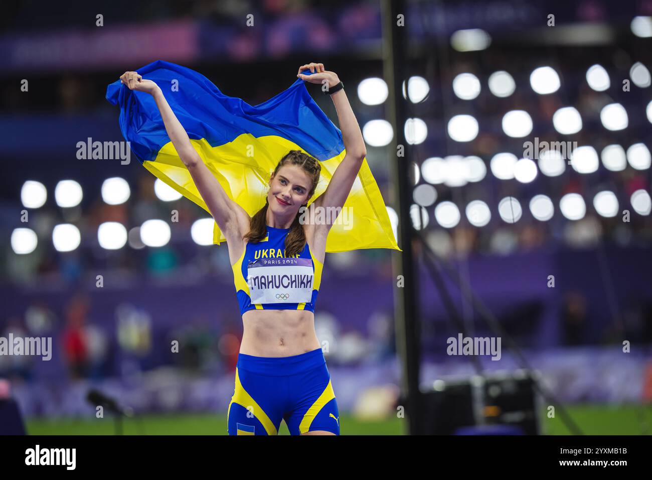 Yaroslava Mahuchikh celebrating her medal with her country's flag at ...