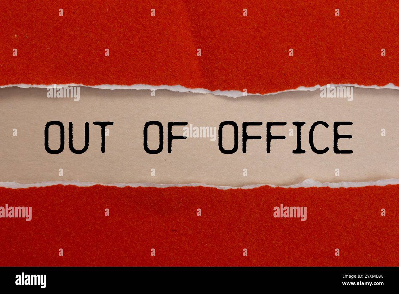Out of office message written on ripped torn red paper with beige ...