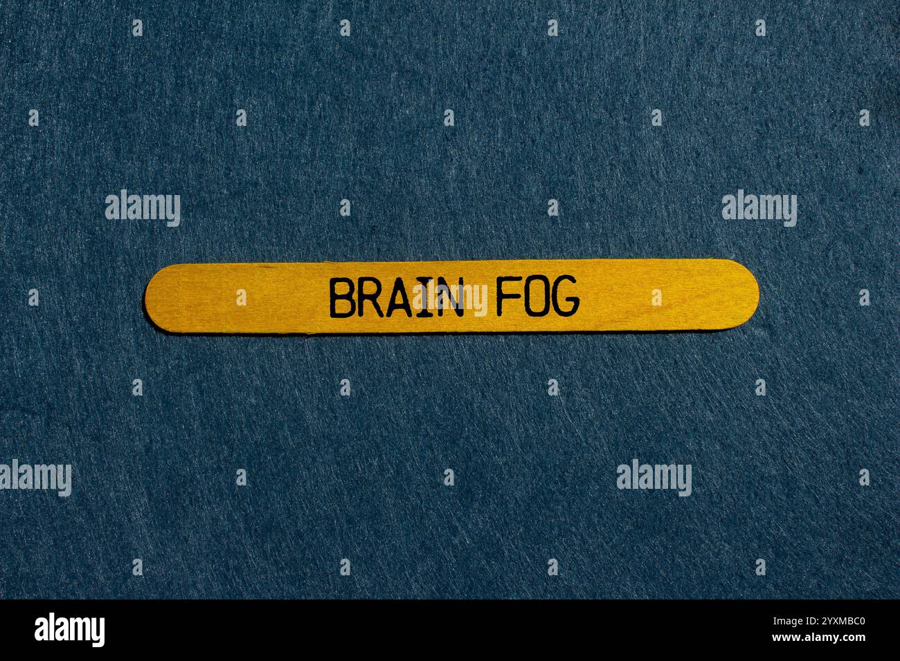 Brain fog message written on yellow wooden stick with gray background ...