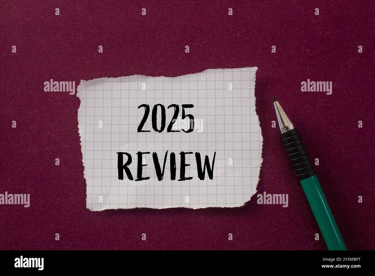 2025 review message written on ripped torn paper piece with purple background. Conceptual 2025 ...